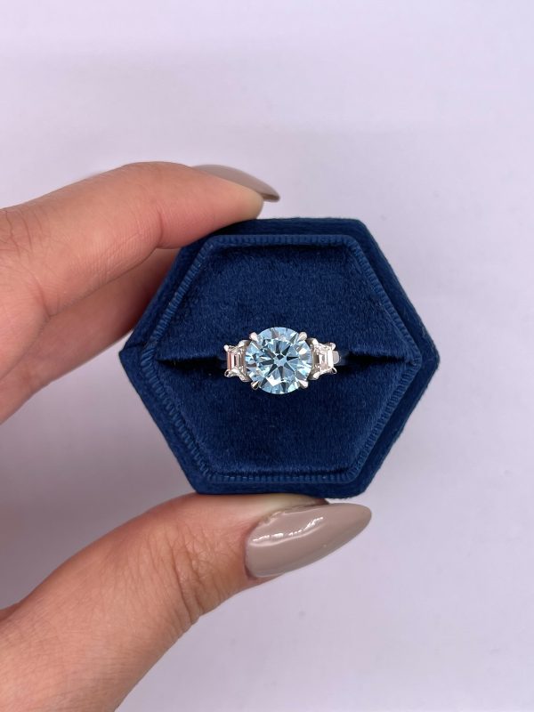 Maya 3.60 Carat Fancy Intense Blue Round Diamond Three Stone Ring Side Trapezoids